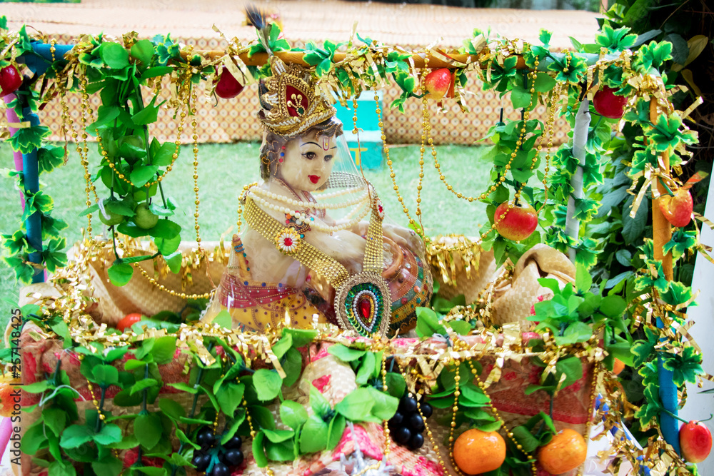 The Hindu God, Lord Krishna, in his childhood form, eating butter ...