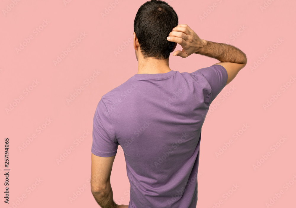 Handsome man on back position looking back while scratching head on ...