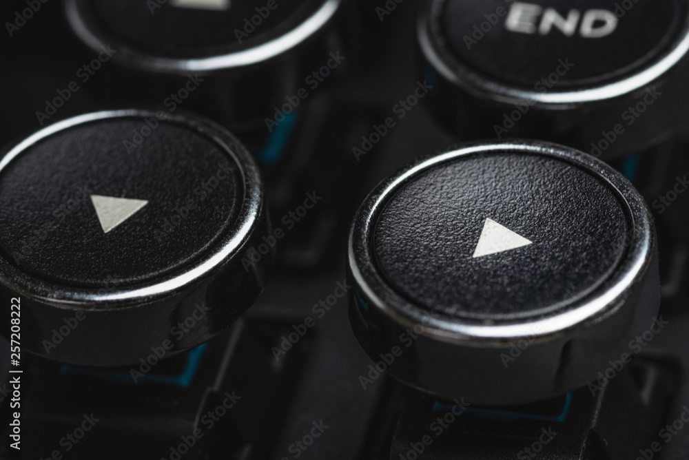 An extreme close-up or macro shot of a round directional arrow key on a ...
