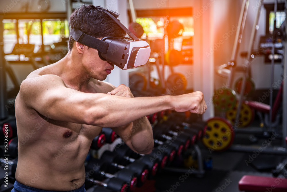 Exercise in gym concept.Asian men have muscle Playing vr (virtual ...