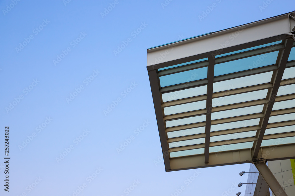 transparent roof and steel structure with clear blue sky background ...