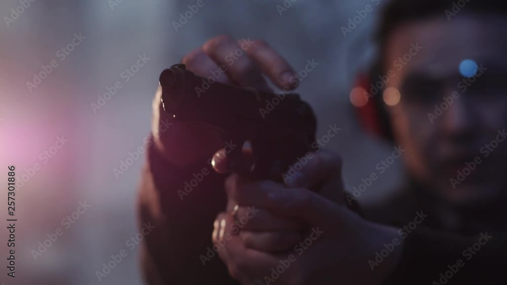 Close up man teaches a woman how to shoot a gun indoors pistol speed ...