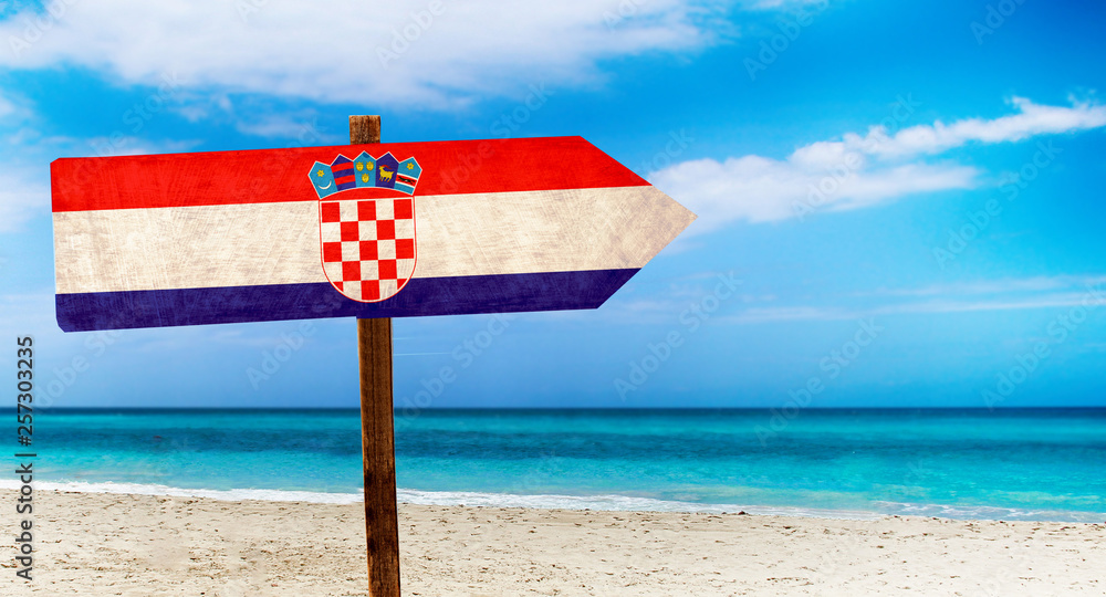 Croatia flag on wooden table sign on beach background. It is summer ...