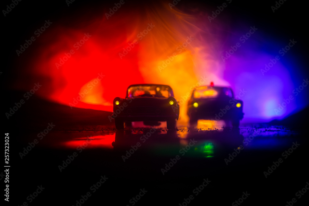Police car chasing a car at night with fog background. 911 Emergency ...