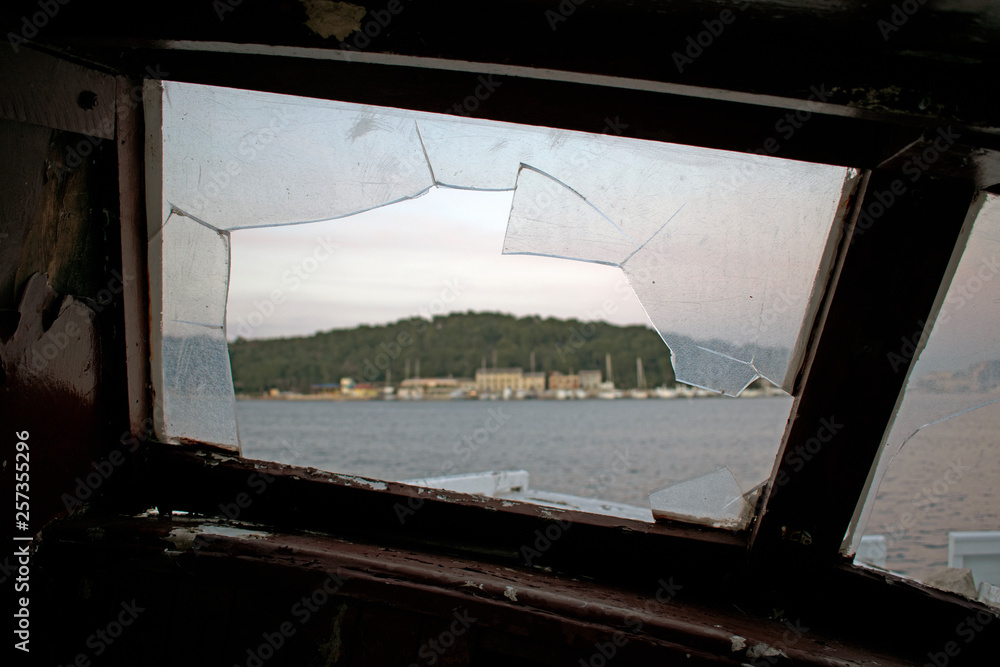 View through a broken window of an old ship Stock Photo | Adobe Stock