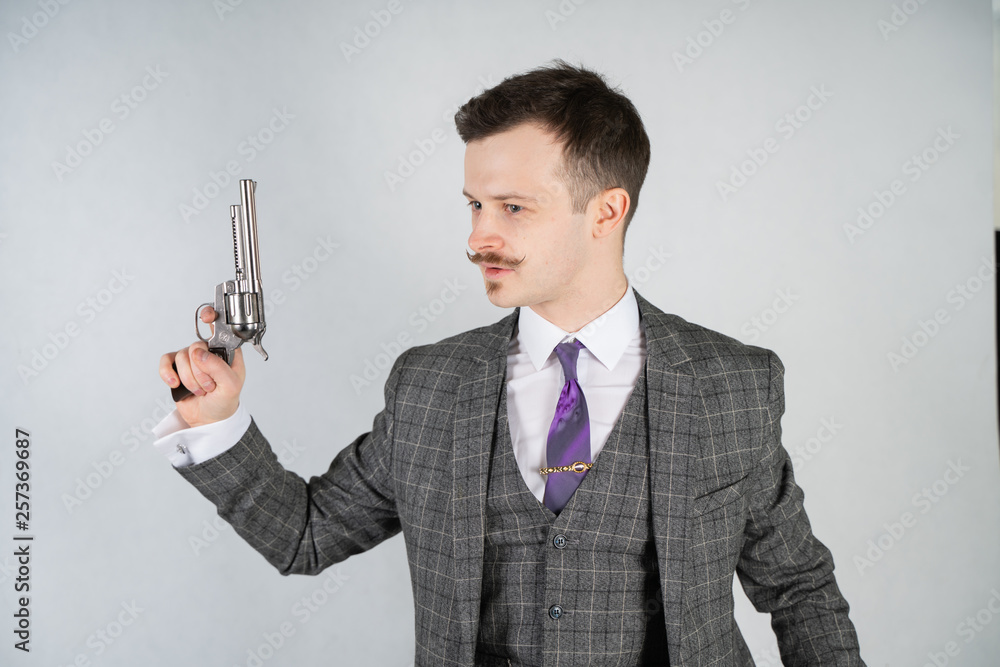 vintage English detective with a checkered business suit with a gun on ...