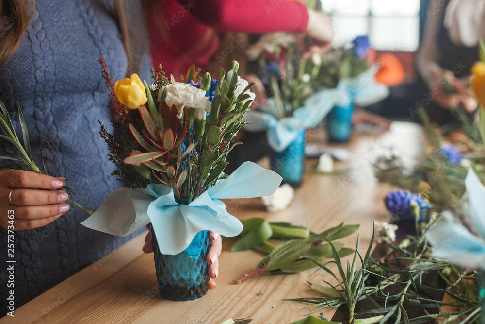 Women on the master-class on floristics. Young ladies making floral ...