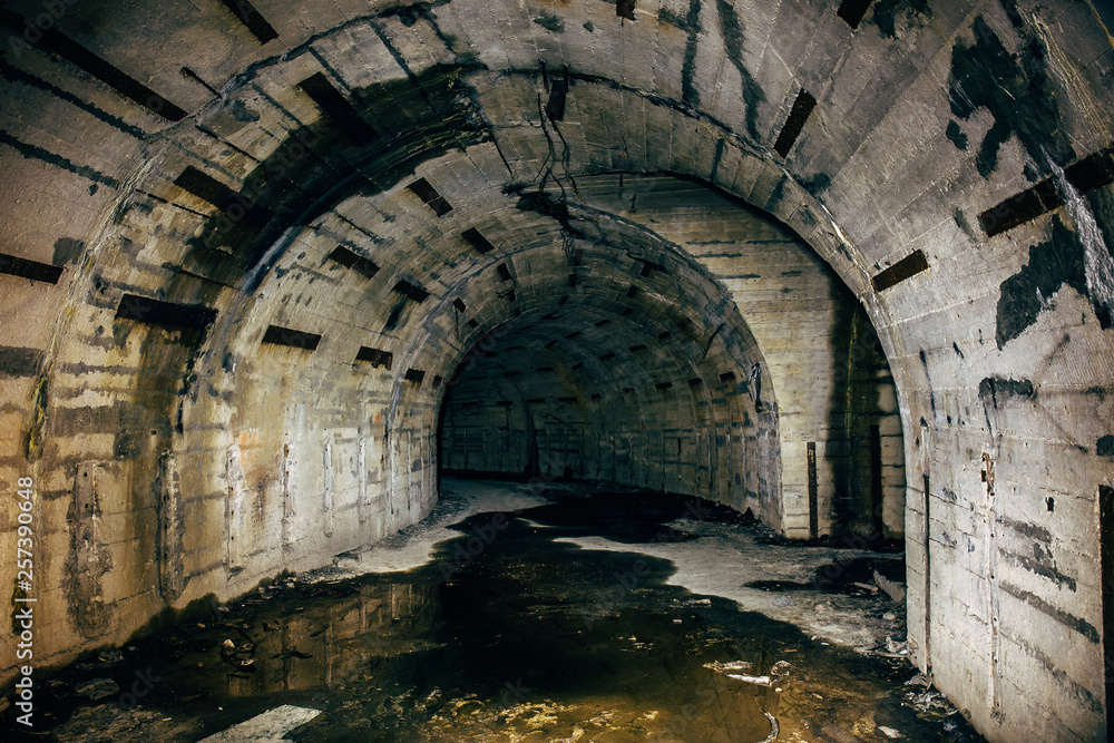 Long underground tunnel or corridor in abandoned Soviet military bunker ...