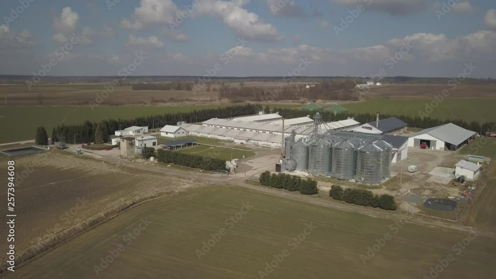 The view from the height of a large farm located among the green hilly ...