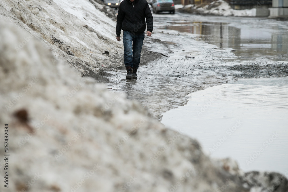 warming in early spring, snow melts turning into slush and puddles ...