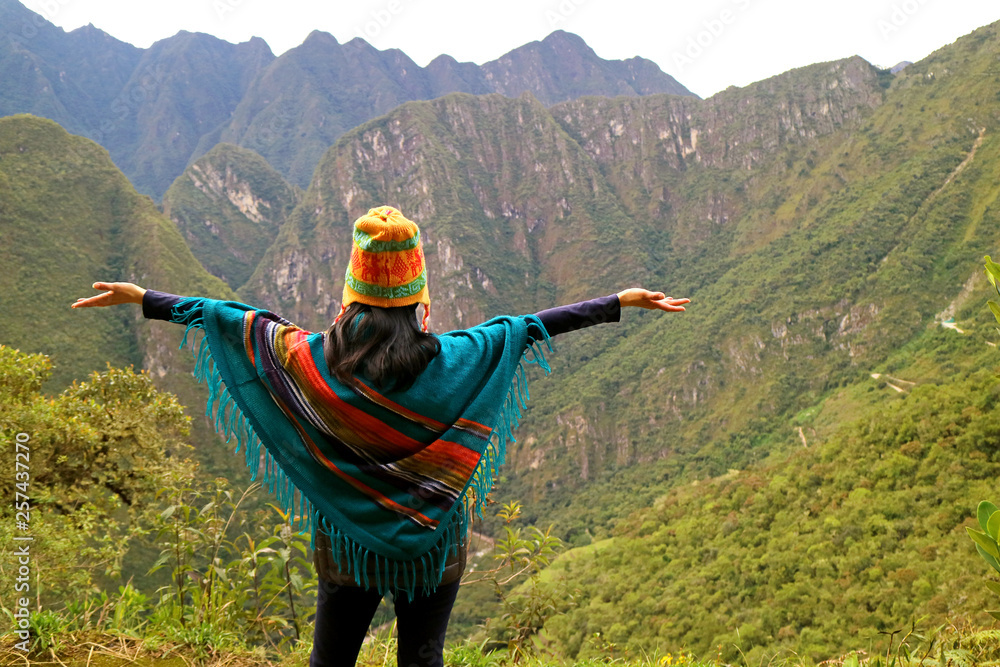 One female raising her arms at the viewpoint on Huayna Picchu mountain ...