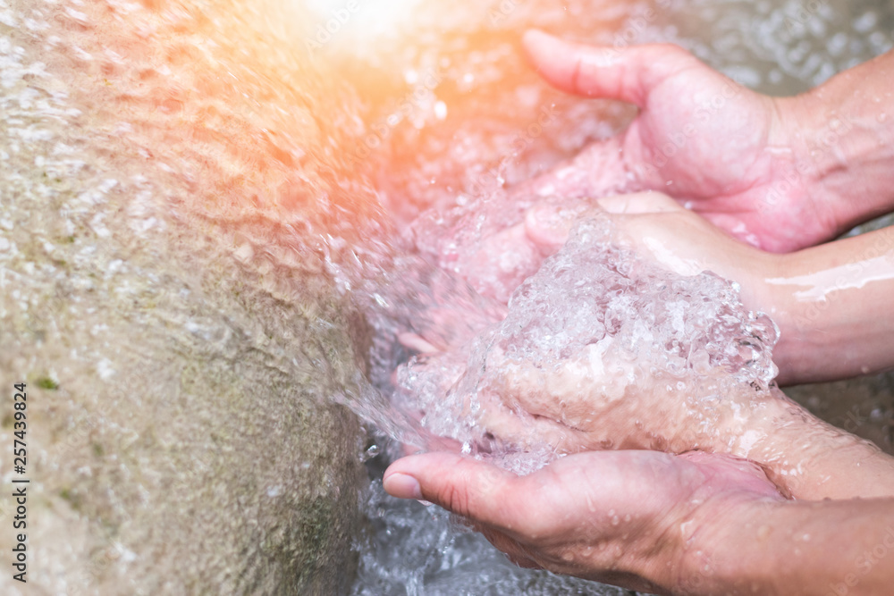 Father's hand hold daughter hands to save water at waterfall. National ...