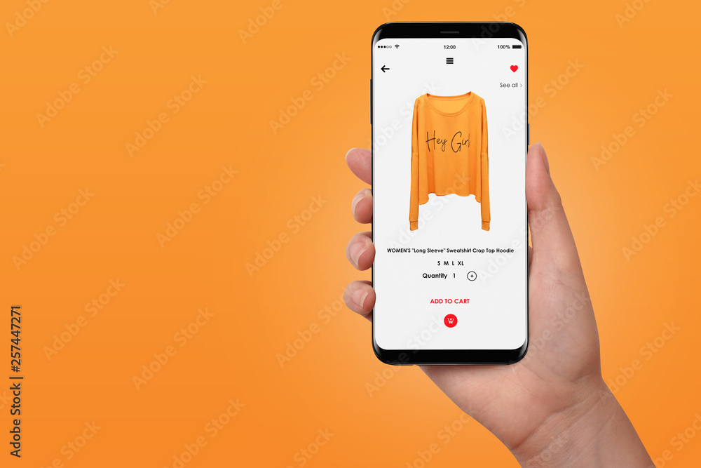 Female hand buying yellow hoodie online on her phone, isolated on ...