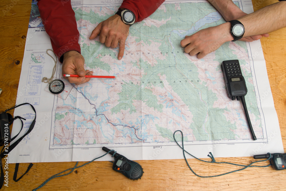 Two men plan out the next day's route in the Canadian Rockies. Stock ...