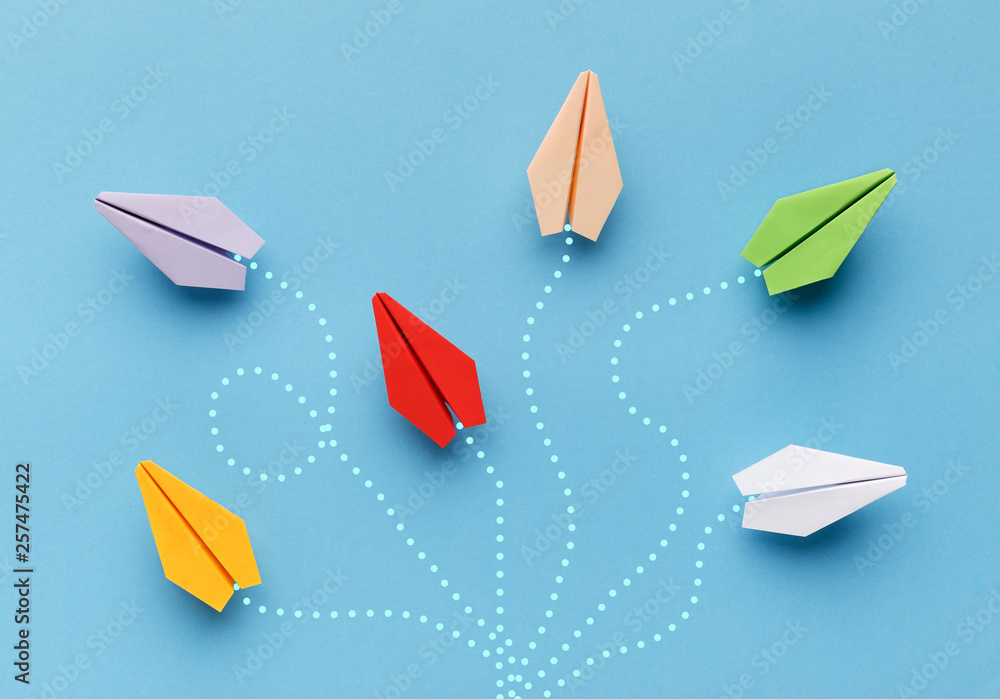 Paper planes with route trace on blue background Stock Photo | Adobe Stock