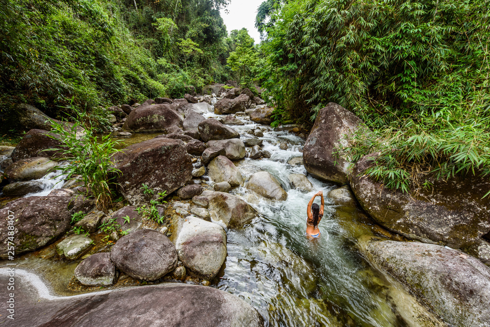 Woman bathing in river, Rio de Janeiro, Brazil Stock Photo | Adobe Stock