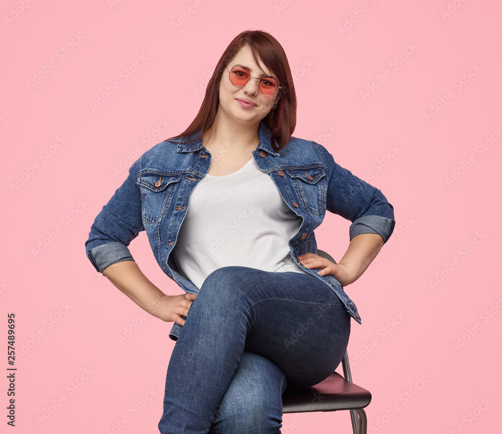 Confident plumpy girl in denim outfit Stock Photo | Adobe Stock