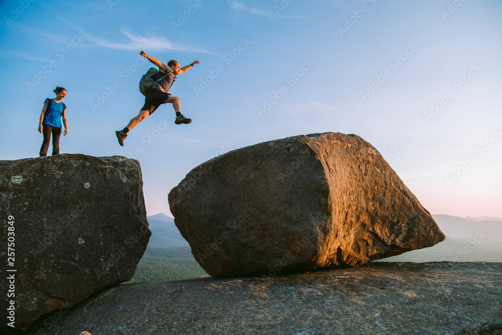 Man jumping across boulders, Pitchoff?Mountain, Adirondack Mountains ...