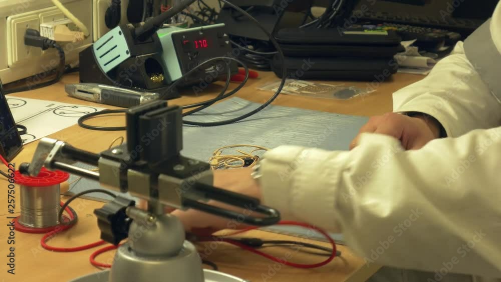 Electronics engineer testing head mic in his workshop and melting ...