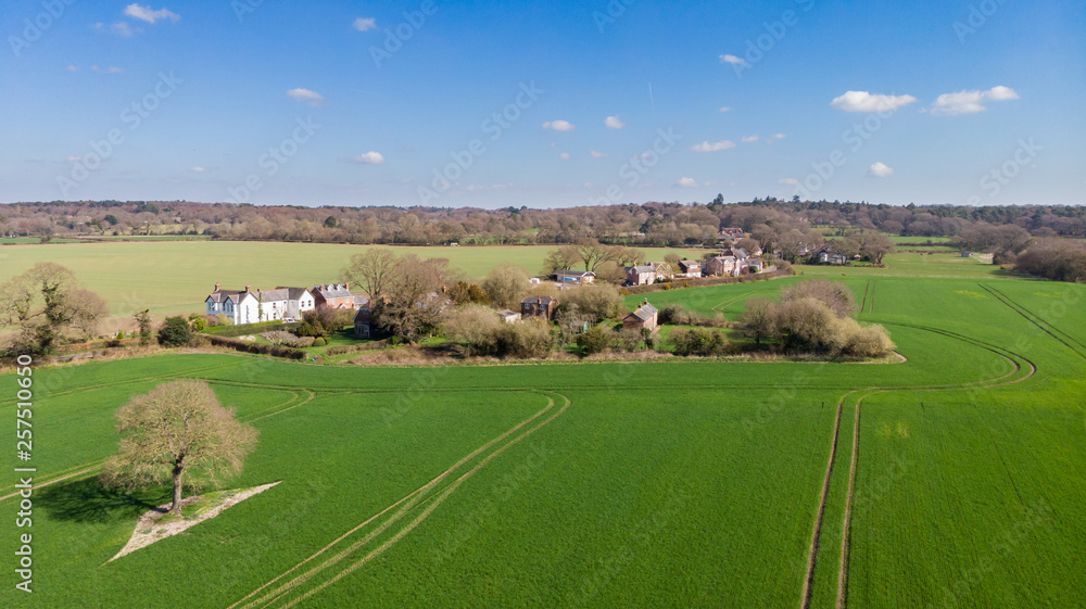 An aerial view of a scenic rural village in the middle of green fields ...