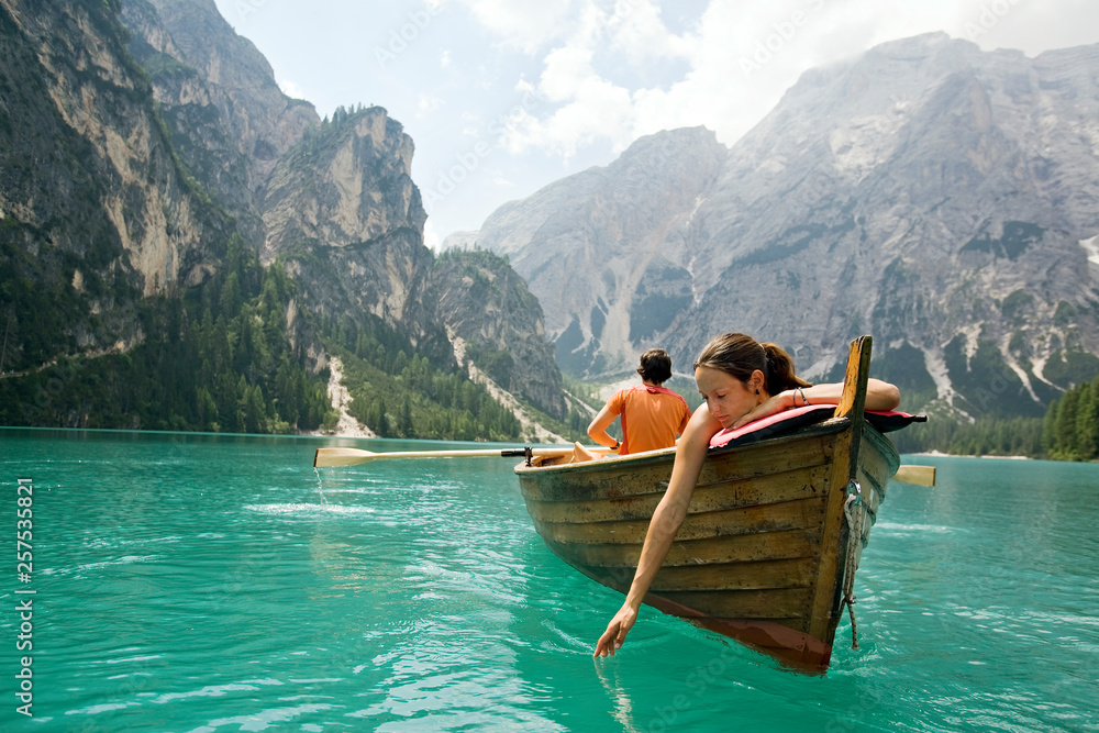 Couple in a row boat on azure Lago di Braies, Italy Stock Photo | Adobe ...