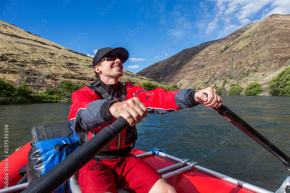 Man rowing on raft down Deschutes River Stock Photo | Adobe Stock