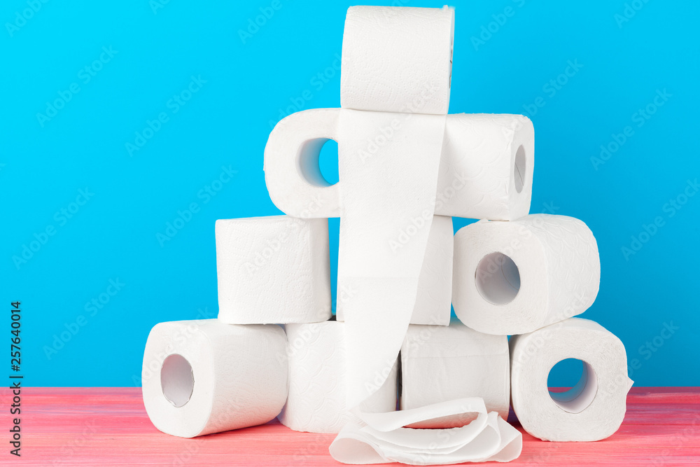 Toilet paper stack on bright blue background Stock Photo | Adobe Stock