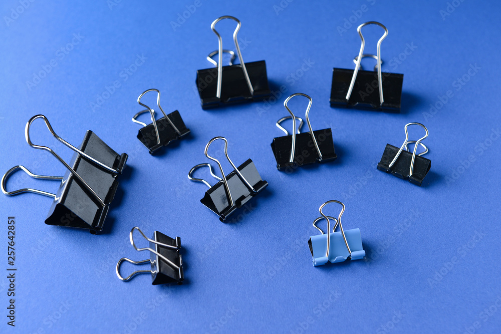 Paper clip whose color and size differ from those of the other ones ...