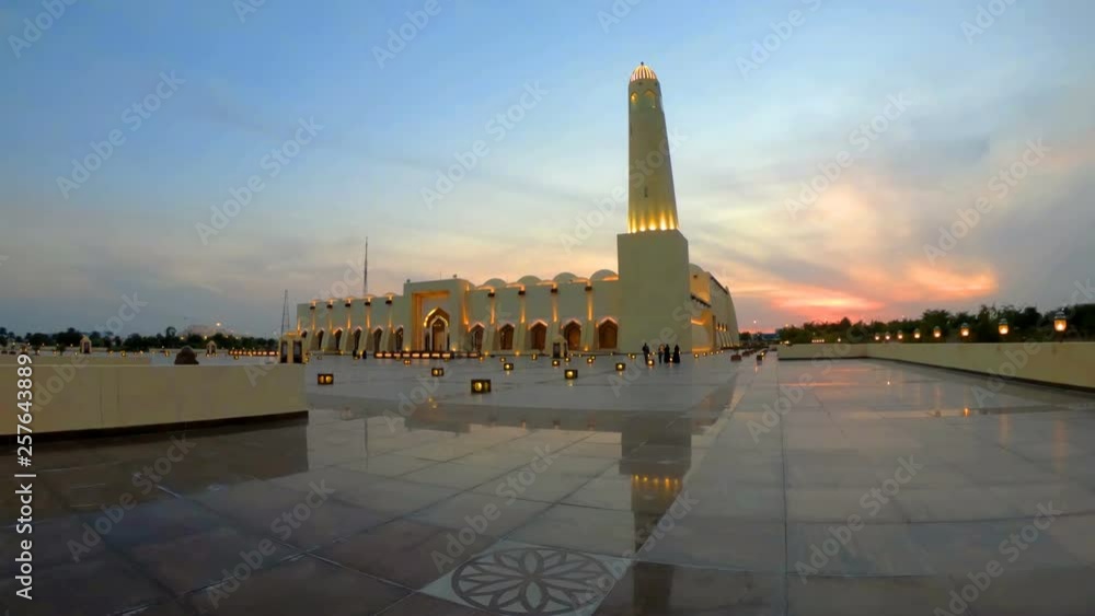 Scenic Doha Grand Mosque with a minaret at sunset light reflecting on ...