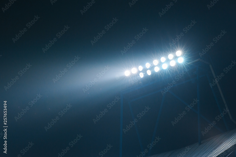 Stadium lights against dark night sky background. Soccer match lights ...