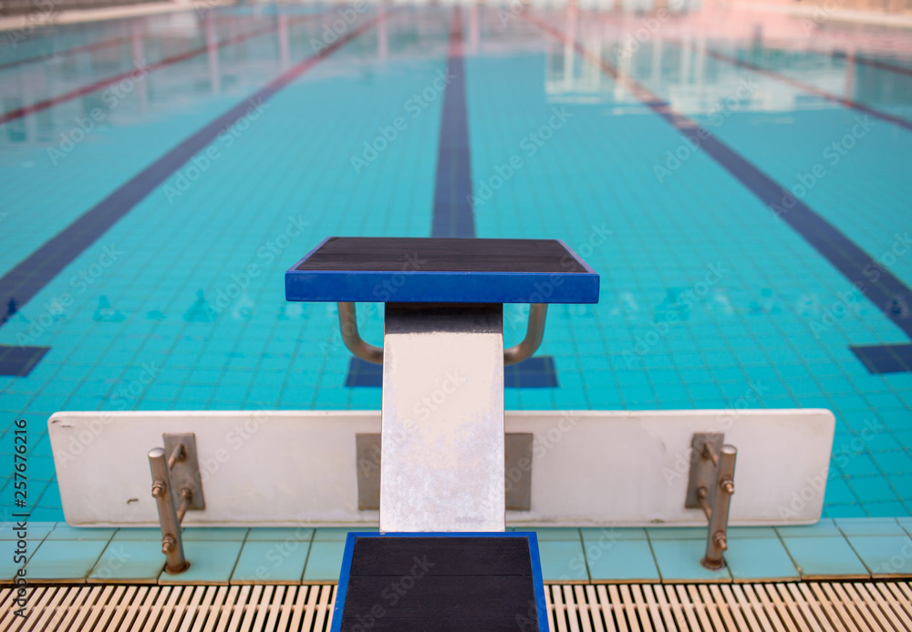 Starting blocks in row by the swimming pool, selective focus. Jump ...
