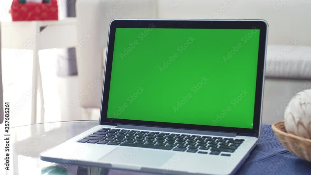 Laptop Computer Showing Green Chroma Key Screen Stands on a Desk in the ...