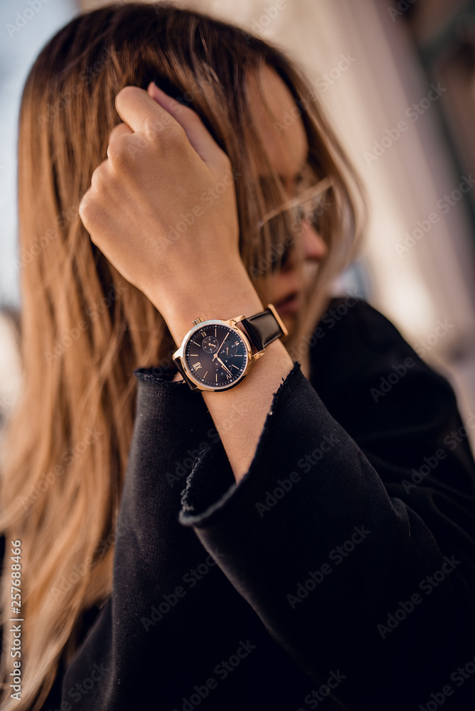 Beautiful black watch on woman hand Stock Photo | Adobe Stock