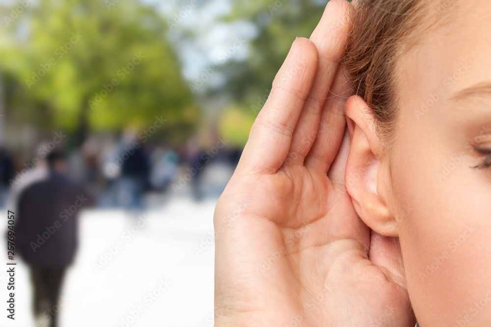 Girl listening with her hand on an ear cose up Stock Photo | Adobe Stock