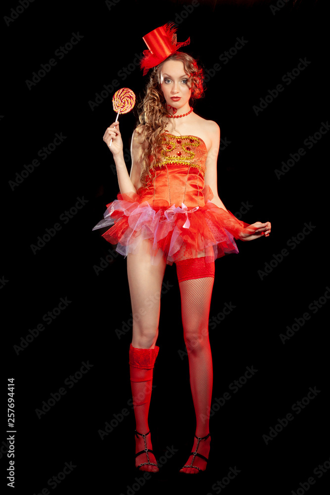 Sexy Burlesque Dancer Stripper Posing With Sweet Lollipop In Red