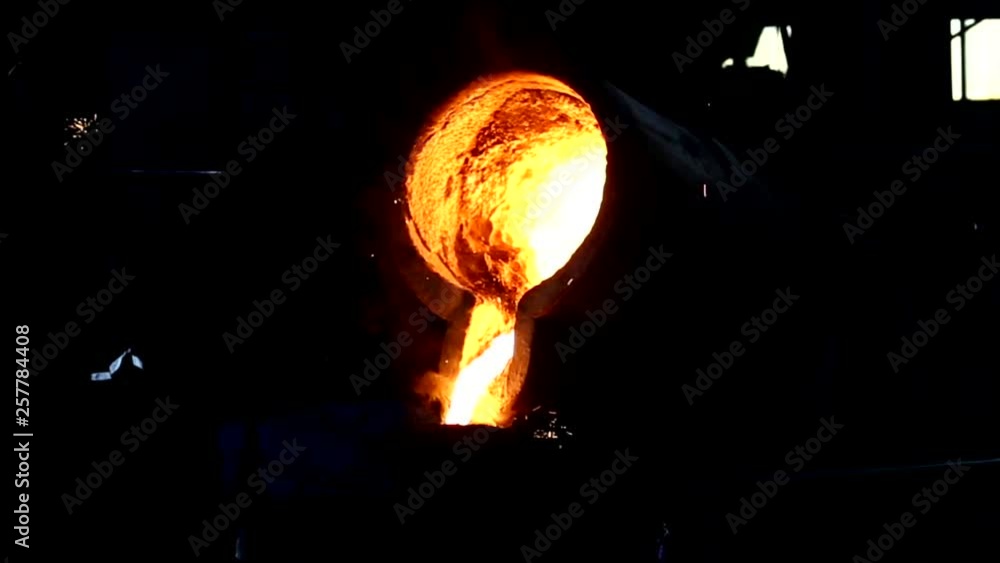 metal casting process with red high temperature fire in metal part ...