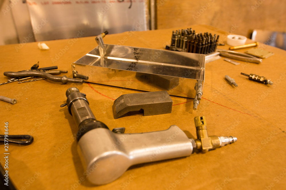 Rivet set with bucking bar and cleco clamps holding metal tray under ...