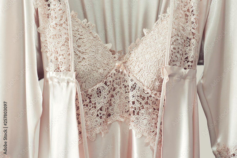 Lace nightgown and cream silk robe on pink background Stock Photo ...