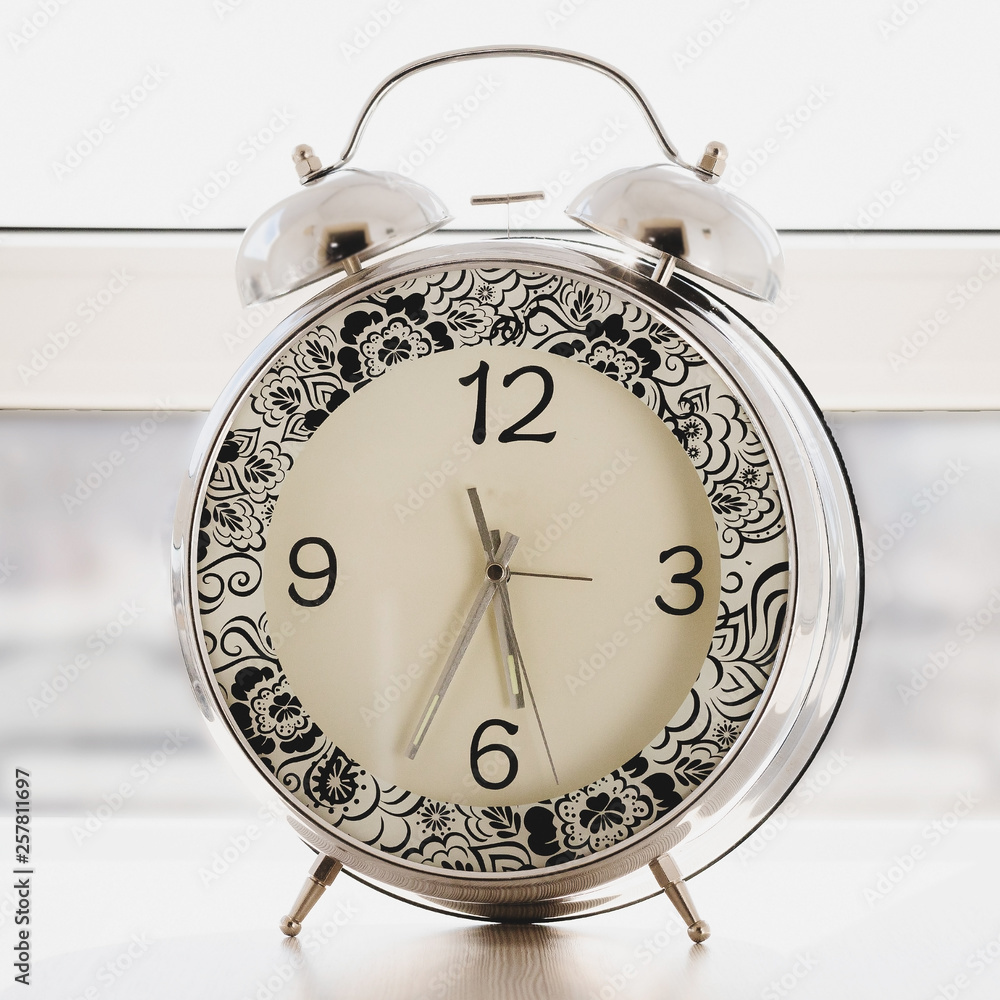 A view of a silver, large wall clock. Side view of a clock showing the ...