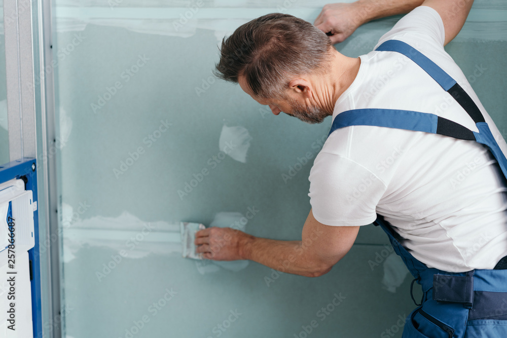 Applying putty to the gypsum plasterboards Stock Photo | Adobe Stock