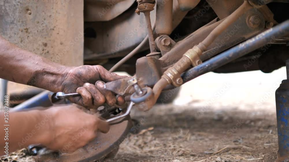 Hands of mechanical using fix wrench tool to spinning bolt of the truck ...