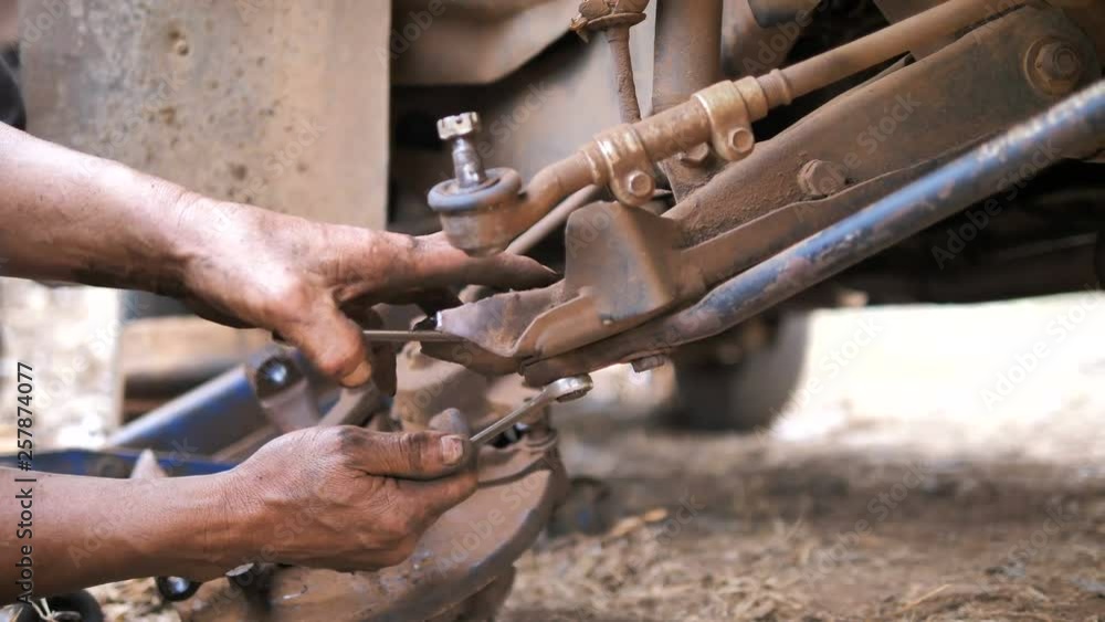 Hands of mechanical using fix wrench tool to spinning bolt of the truck ...