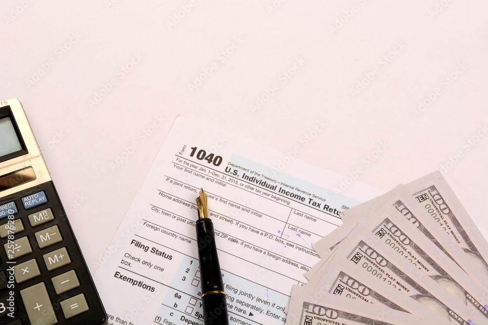 Completing US tax return form 1040 on white background Stock Photo ...