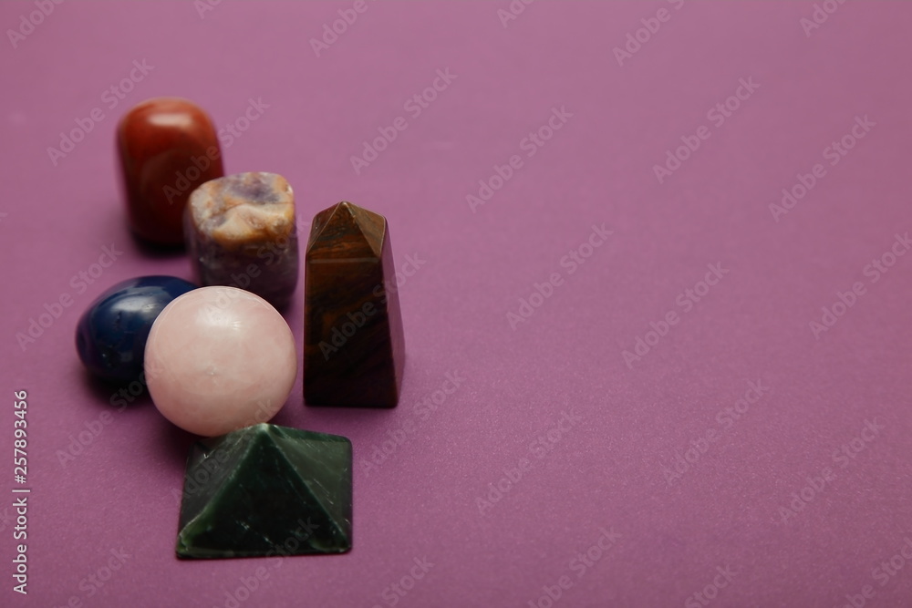 Magic stones and crystals of different shapes and colors lying in bulk ...