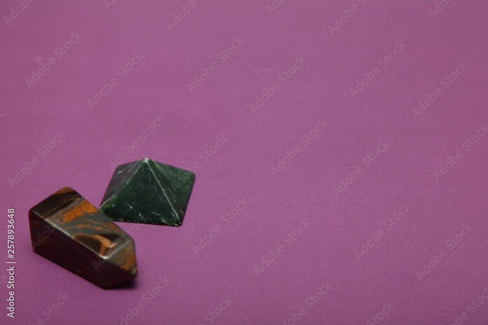 Magic stones and crystals of different shapes and colors lying in bulk ...