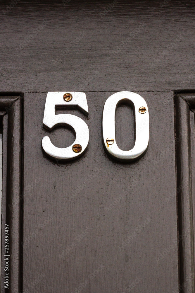 50 on a black house door with he fifty in silver metal numbers Stock ...
