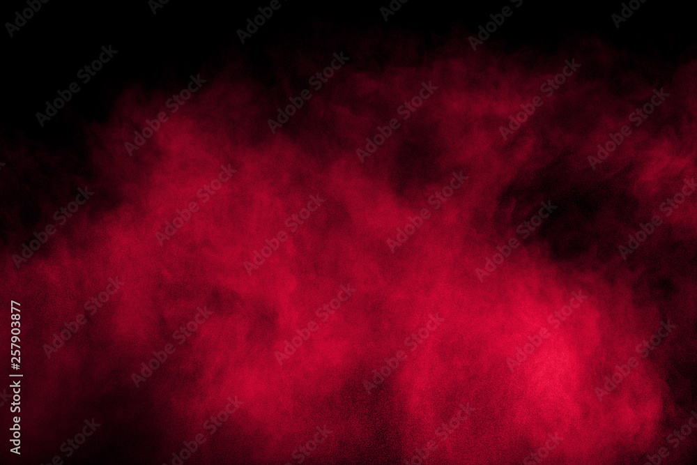 Red color powder explosion on black background.Freeze motion of red ...