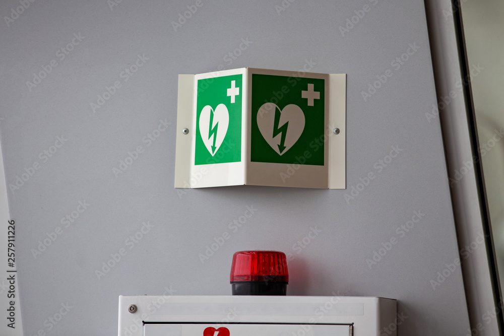 defibrillator attached to the wall at the airport Stock Photo | Adobe Stock