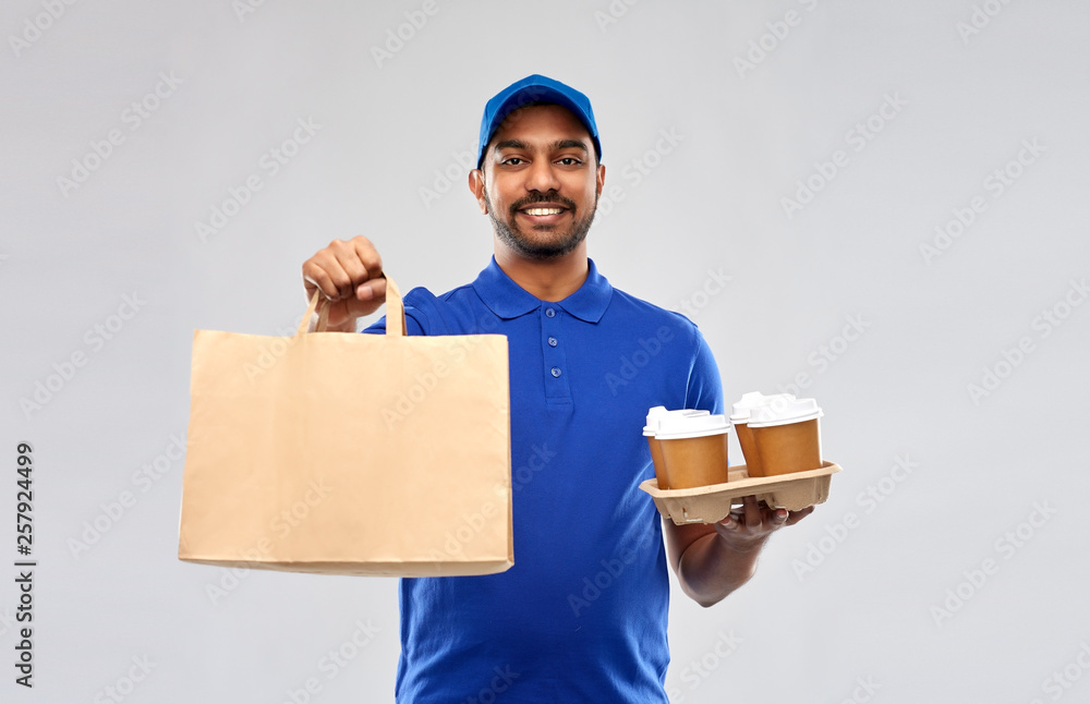 service and people concept - happy indian delivery man with food in bag ...
