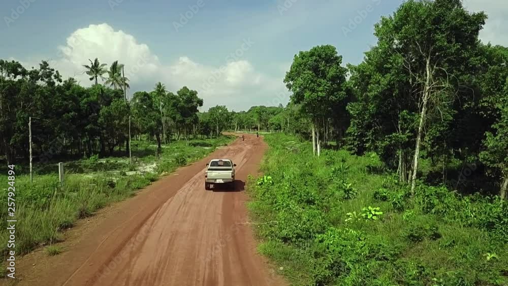 car on the road. road in the jungle. Motorcycle rides along the road ...
